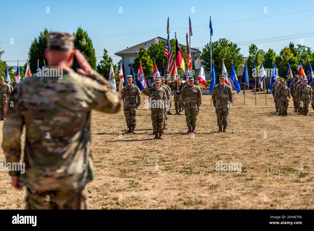 U.S. Soldiers from the 102d Signal Battalion render honors during a ...
