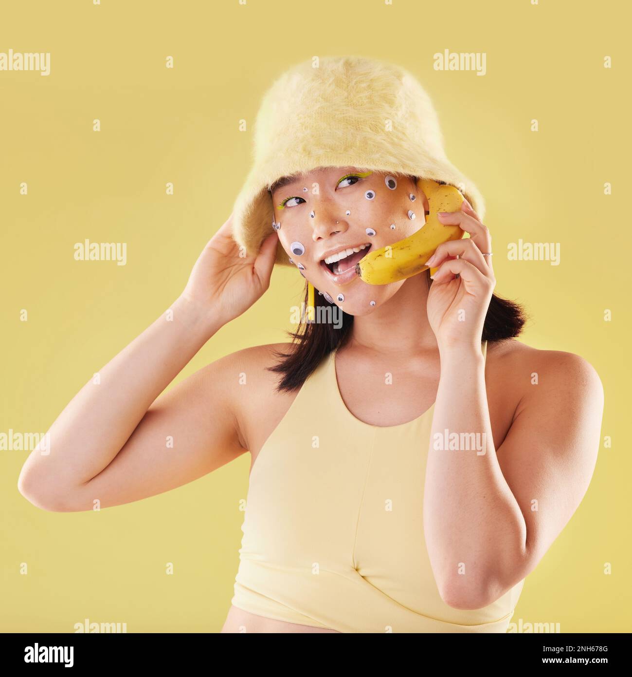Woman, banana phone call and studio with smile, communication and eyes ...