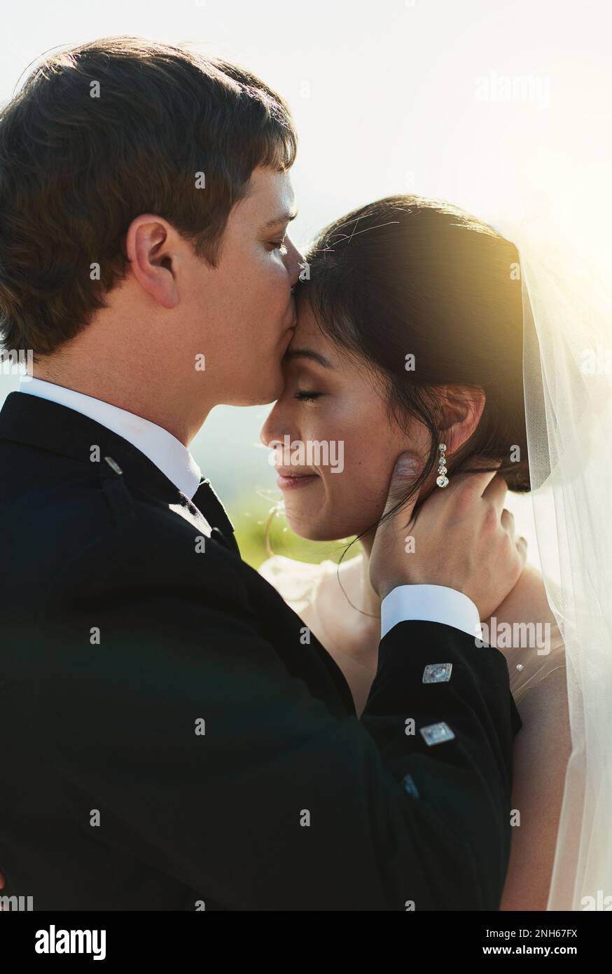 Finally a bit of time alone. a cheerful young groom giving his bride a ...