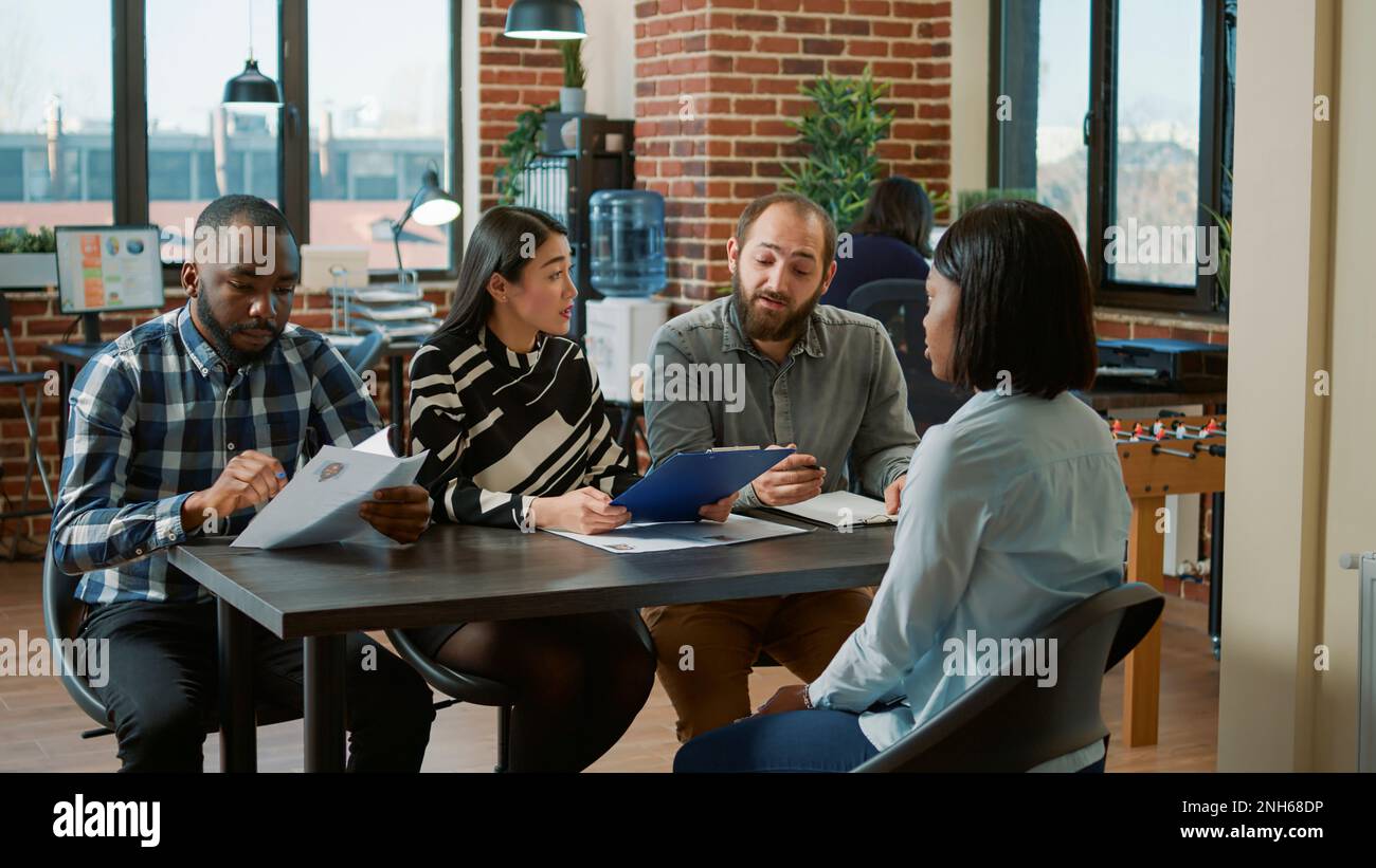 Multiethnic team of HR people interviewing job candidate, analyzing cv ...
