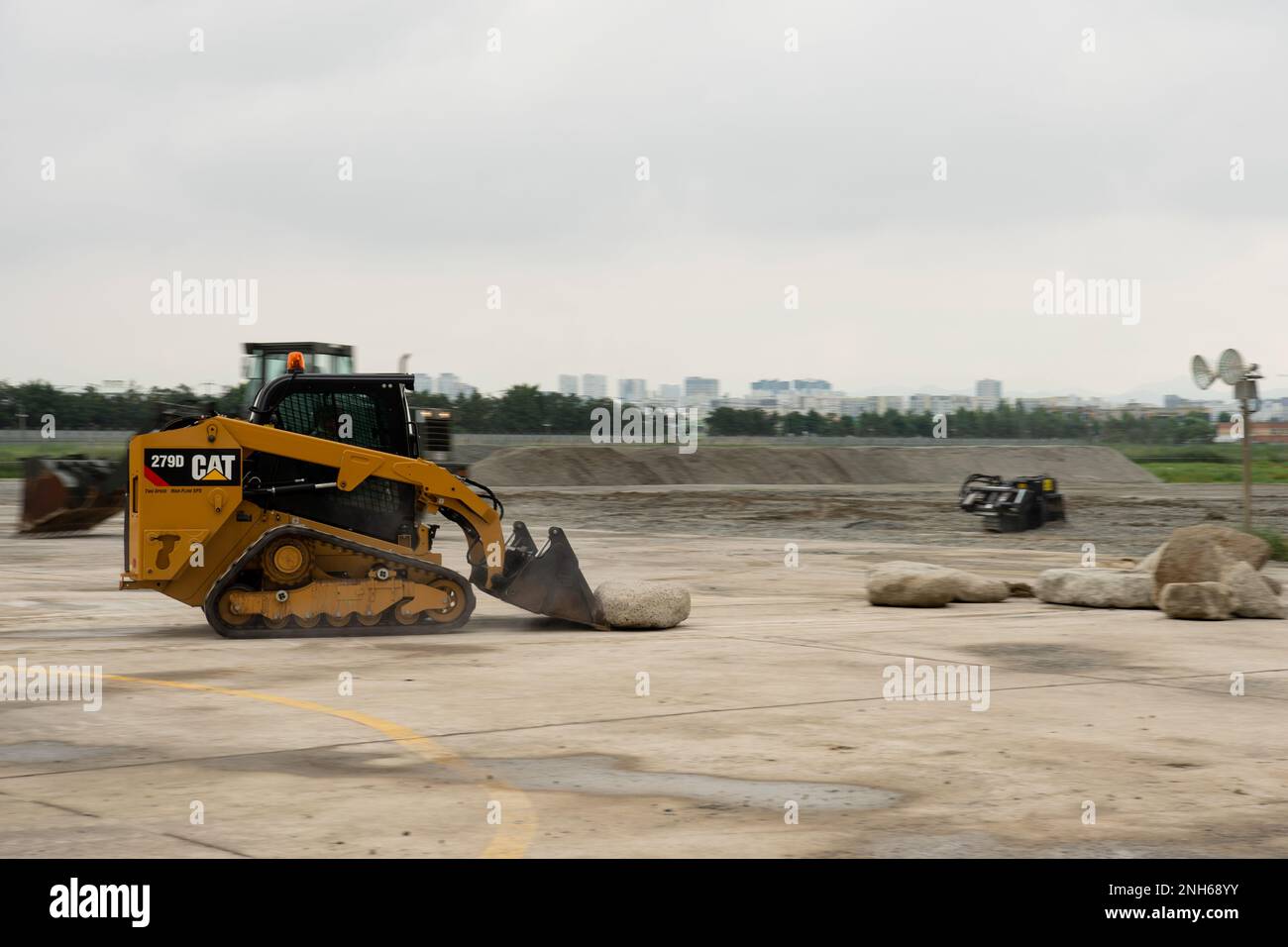A U.S. Air Force (USAF) Civil Engineer Airman uses a Compact Track ...