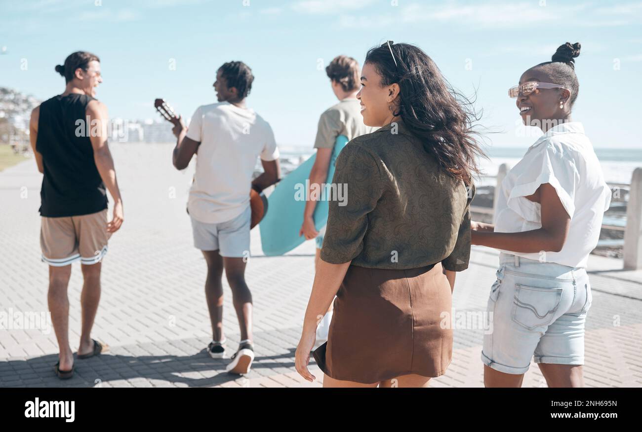 Diversity, walk and friends on beach promenade while on summer vacation ...