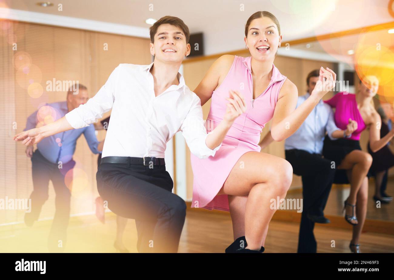 Young couple dancing jive during group training Stock Photo - Alamy