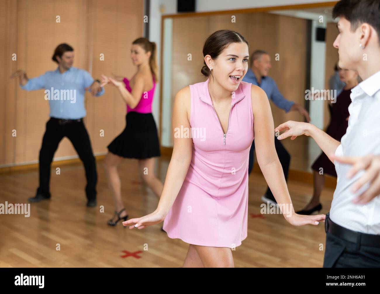 Young happy couple performing a paired dance in ballroom Stock Photo ...