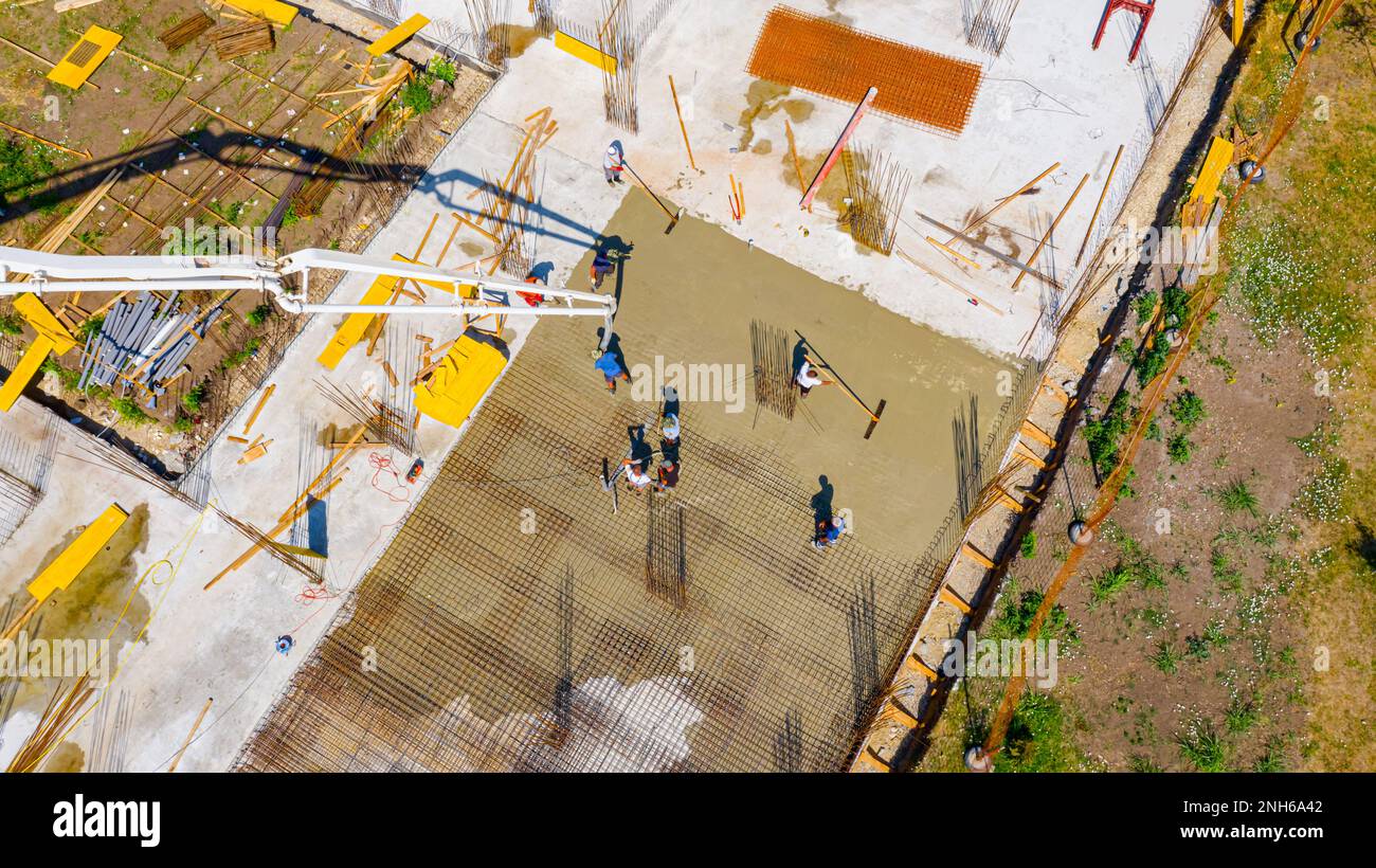 Aerial top view construction worker is directing the pump tube on right ...