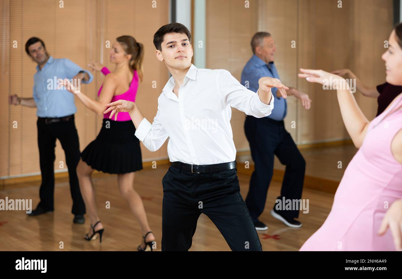 Guy enjoying dancing playful twist with female partner Stock Photo - Alamy