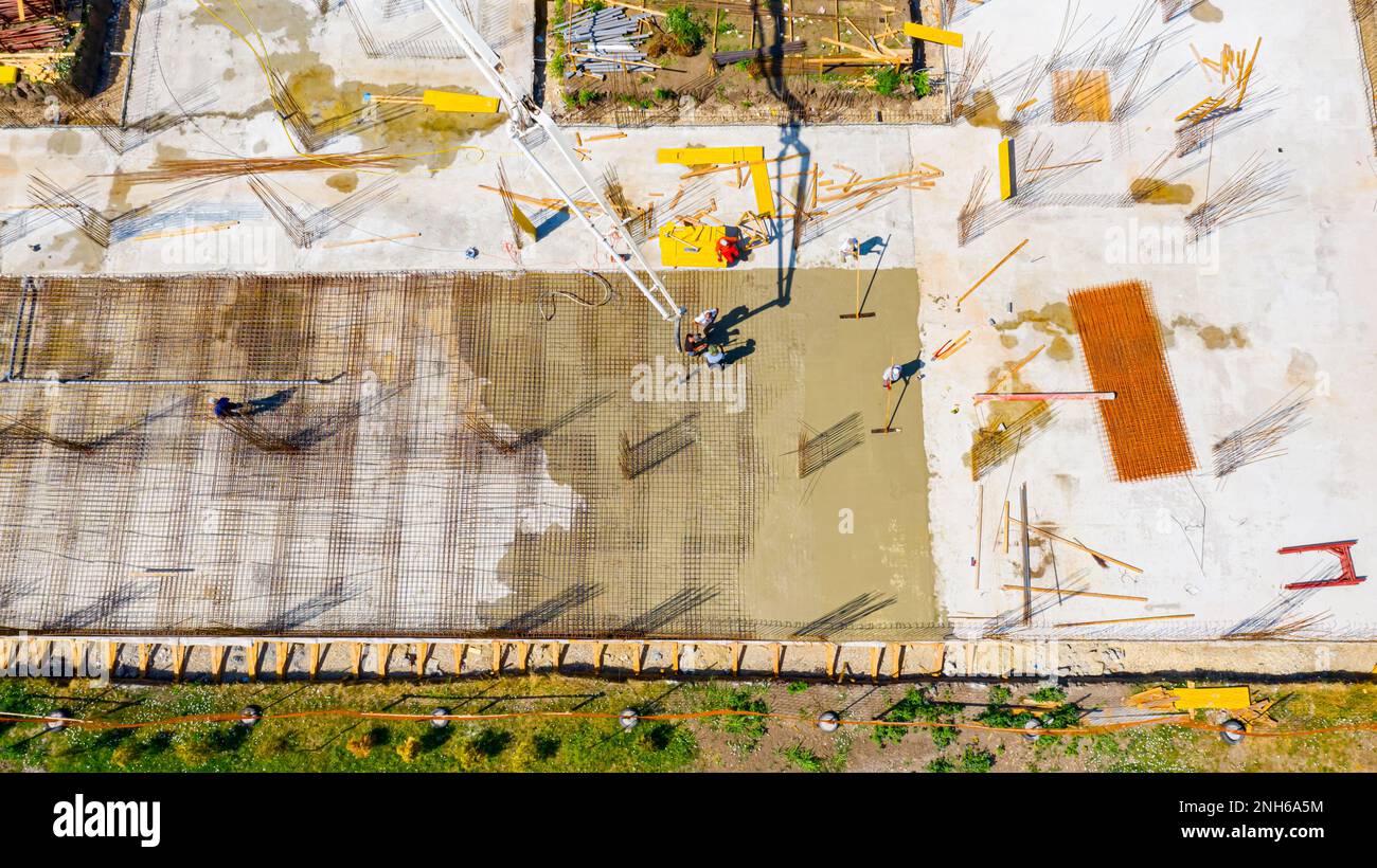 Aerial top view construction worker is directing the pump tube on right ...