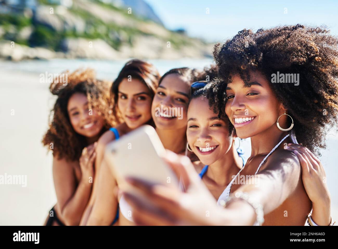 Its not summer without some fun memories. a group of happy young women taking selfies together ...