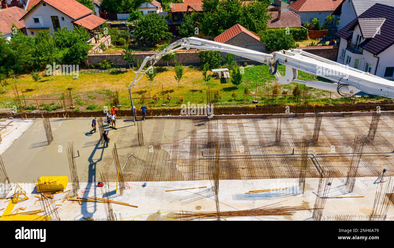 Aerial view construction site, mixer truck pouring concrete into pump ...