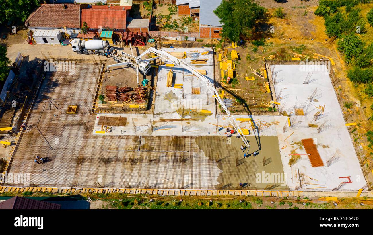 Aerial view construction site, mixer truck pouring concrete into pump ...