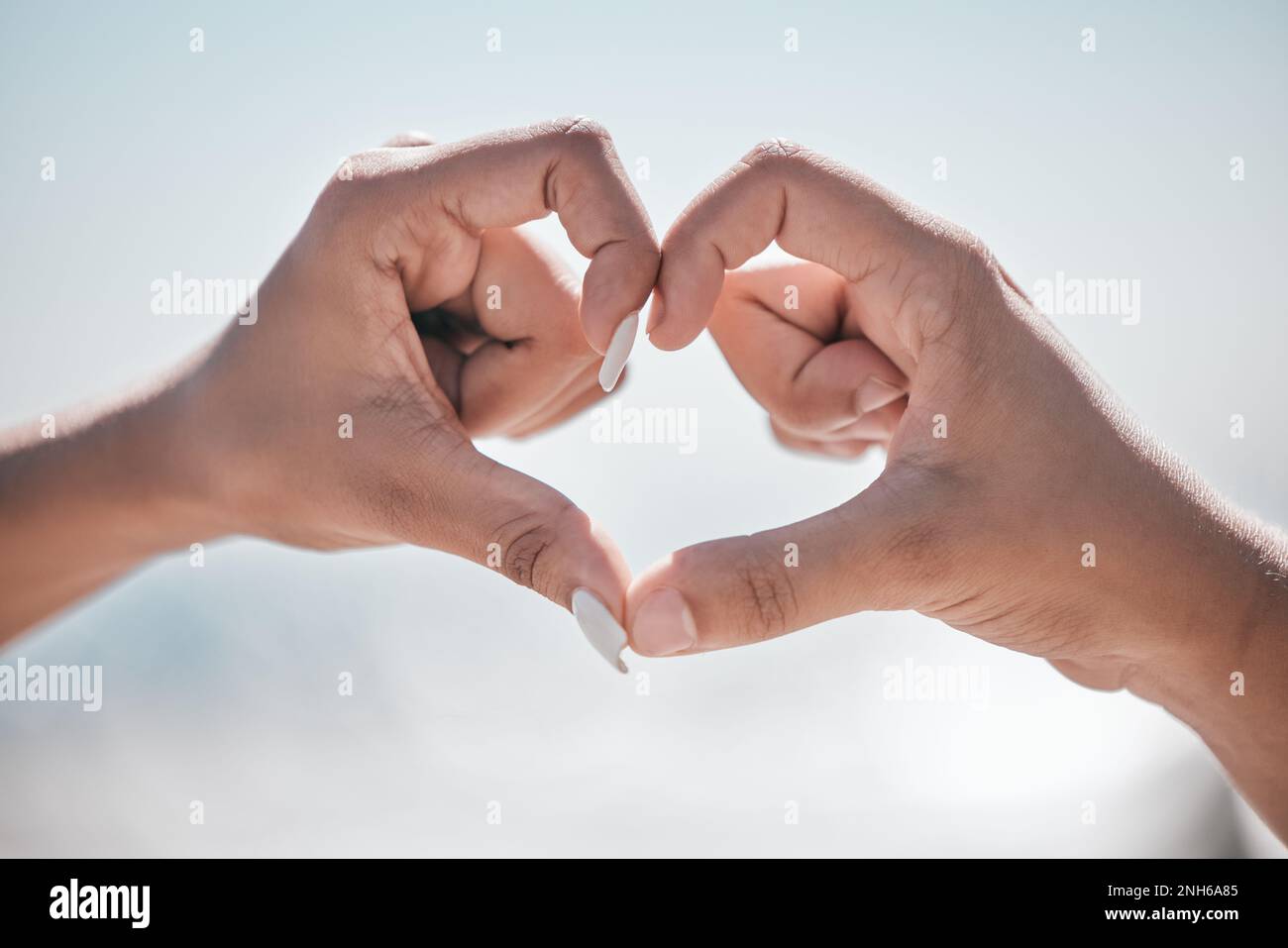 Hand, heart and couple with love, peace and unity sign on mockup, space or blurred background ...
