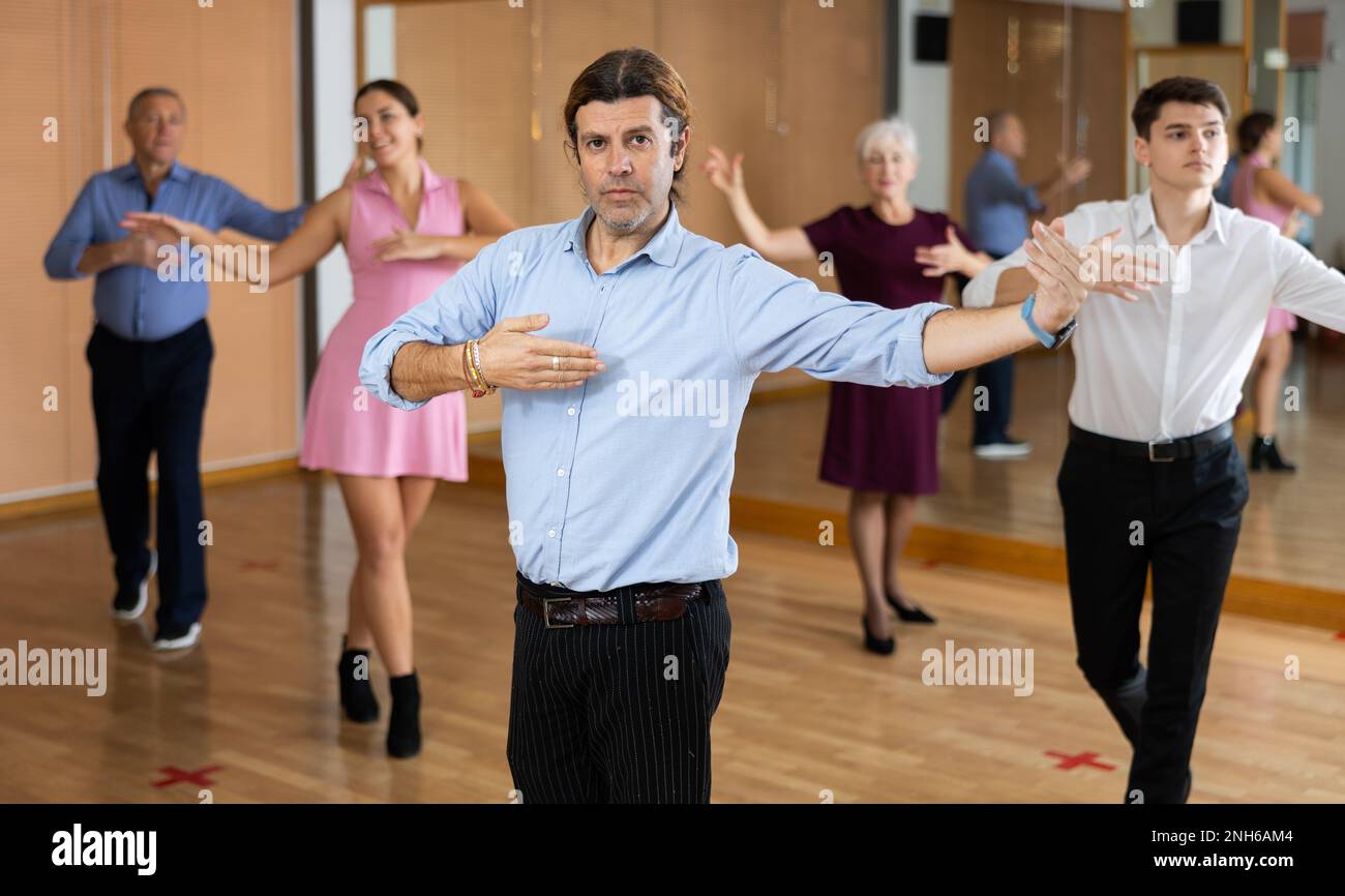 Middle aged man practicing ballroom dance pose in dance studio Stock ...