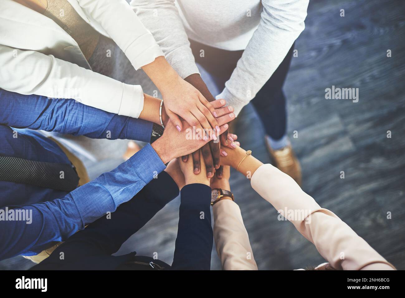 The secret is always teamwork. a group of businesspeople putting their ...