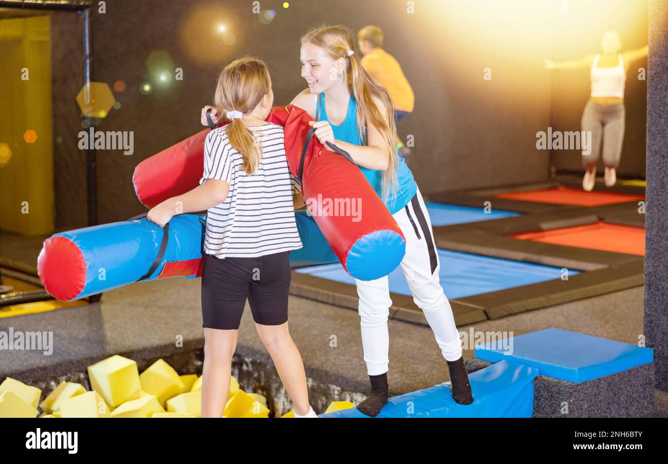 Children having funny wrestling by inflatable logs with his friends in ...