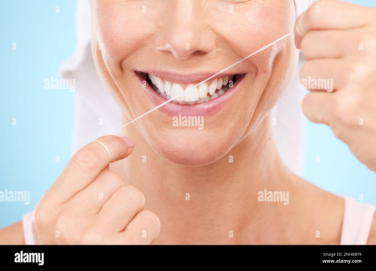 Floss, dental wellness and mouth of woman in studio for beauty, healthy ...
