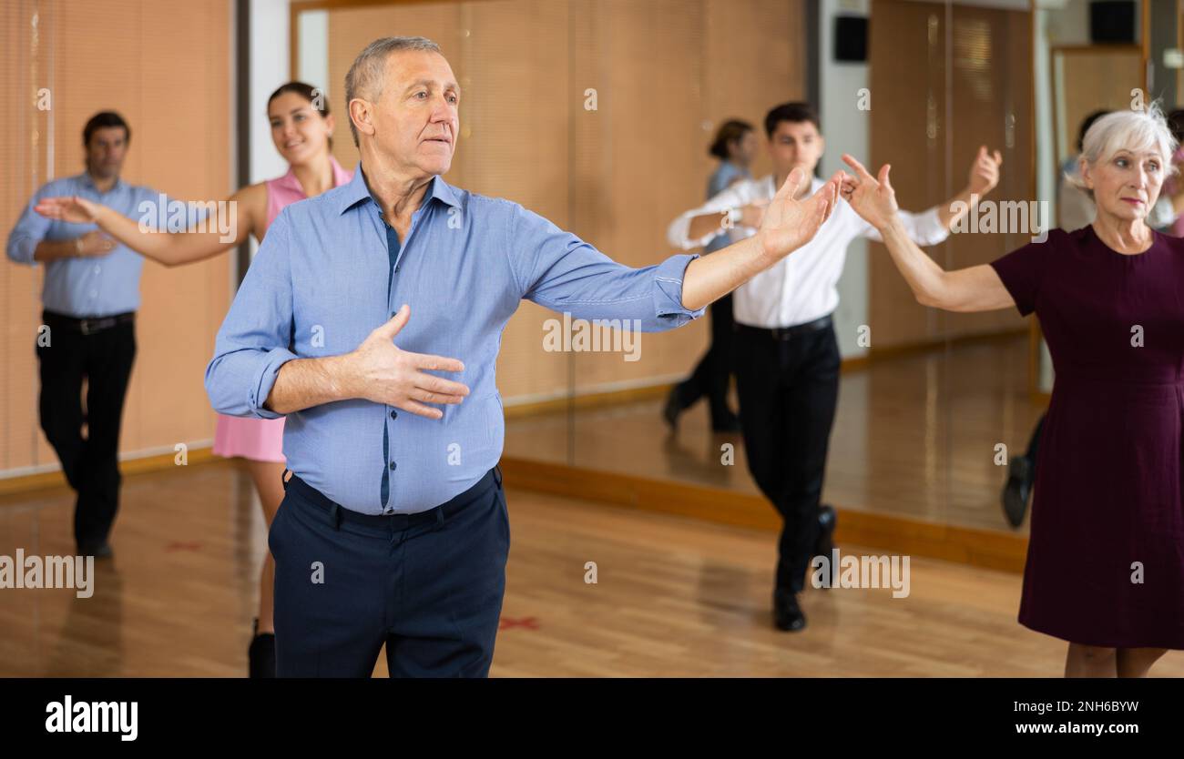 Elderly man practicing ballroom dance pose in dance studio Stock Photo ...