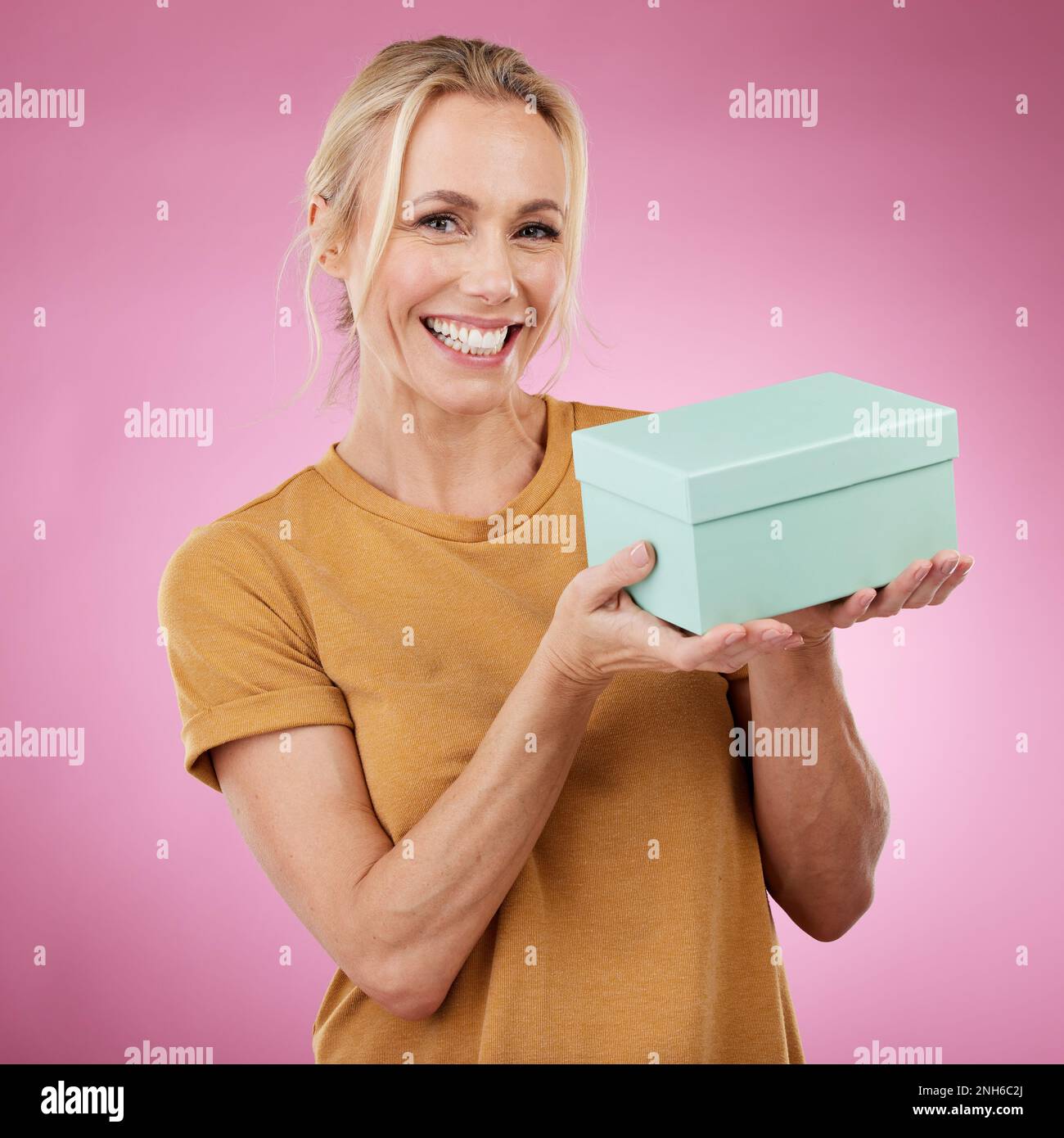Gift, box and portrait of woman in studio with smile, pink background ...