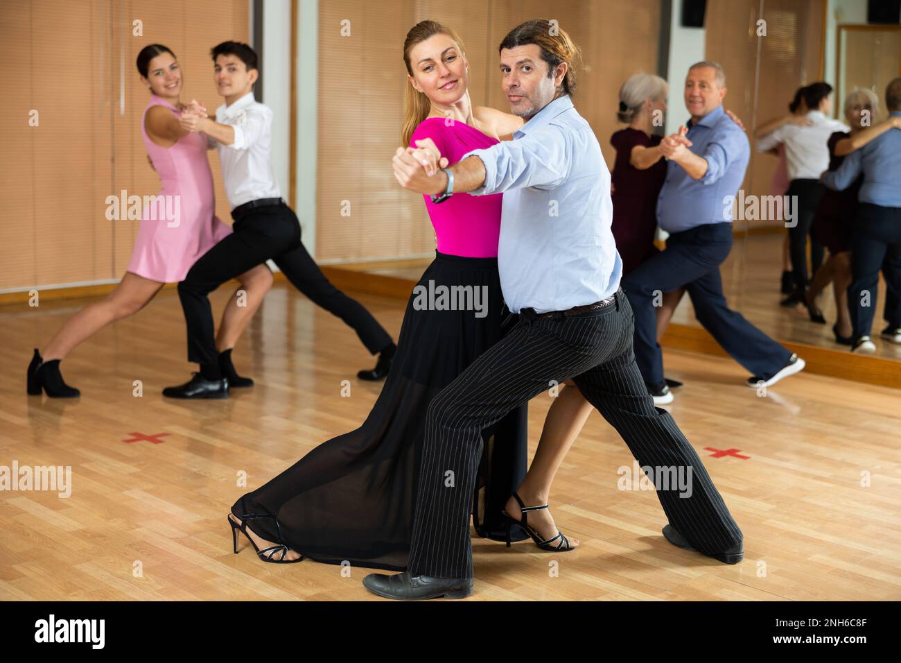 Adult couple enjoying slow foxtrot in dance studio Stock Photo - Alamy