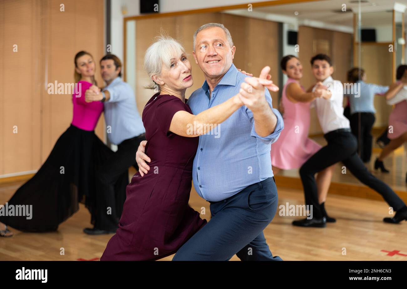 Elderly pair practicing ballroom dance in dance studio Stock Photo - Alamy