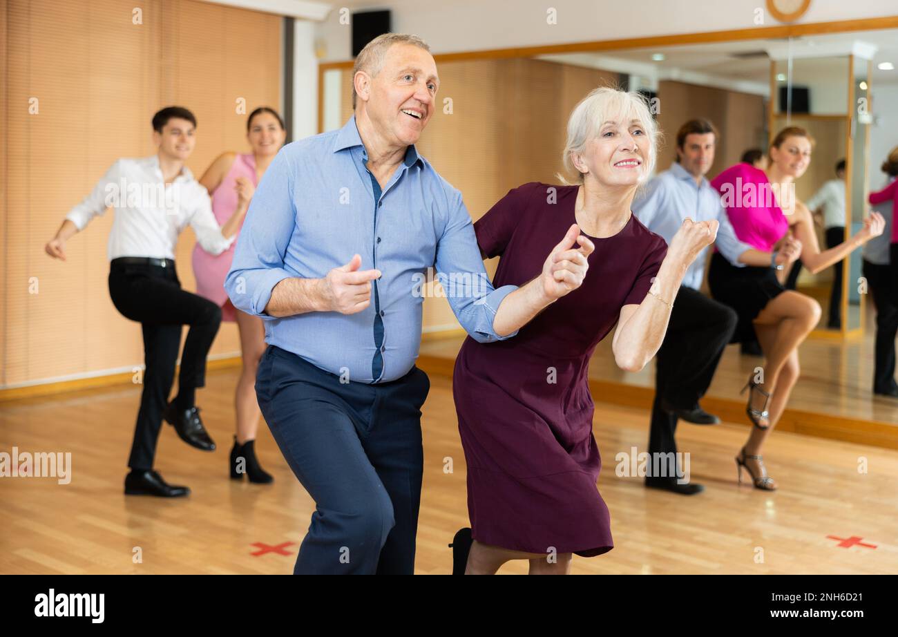 Aged couple dancing jive during group training Stock Photo - Alamy