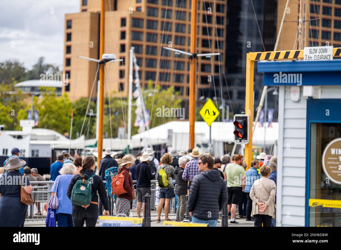 crowd of old people watching an event of tall ships outside in summer ...