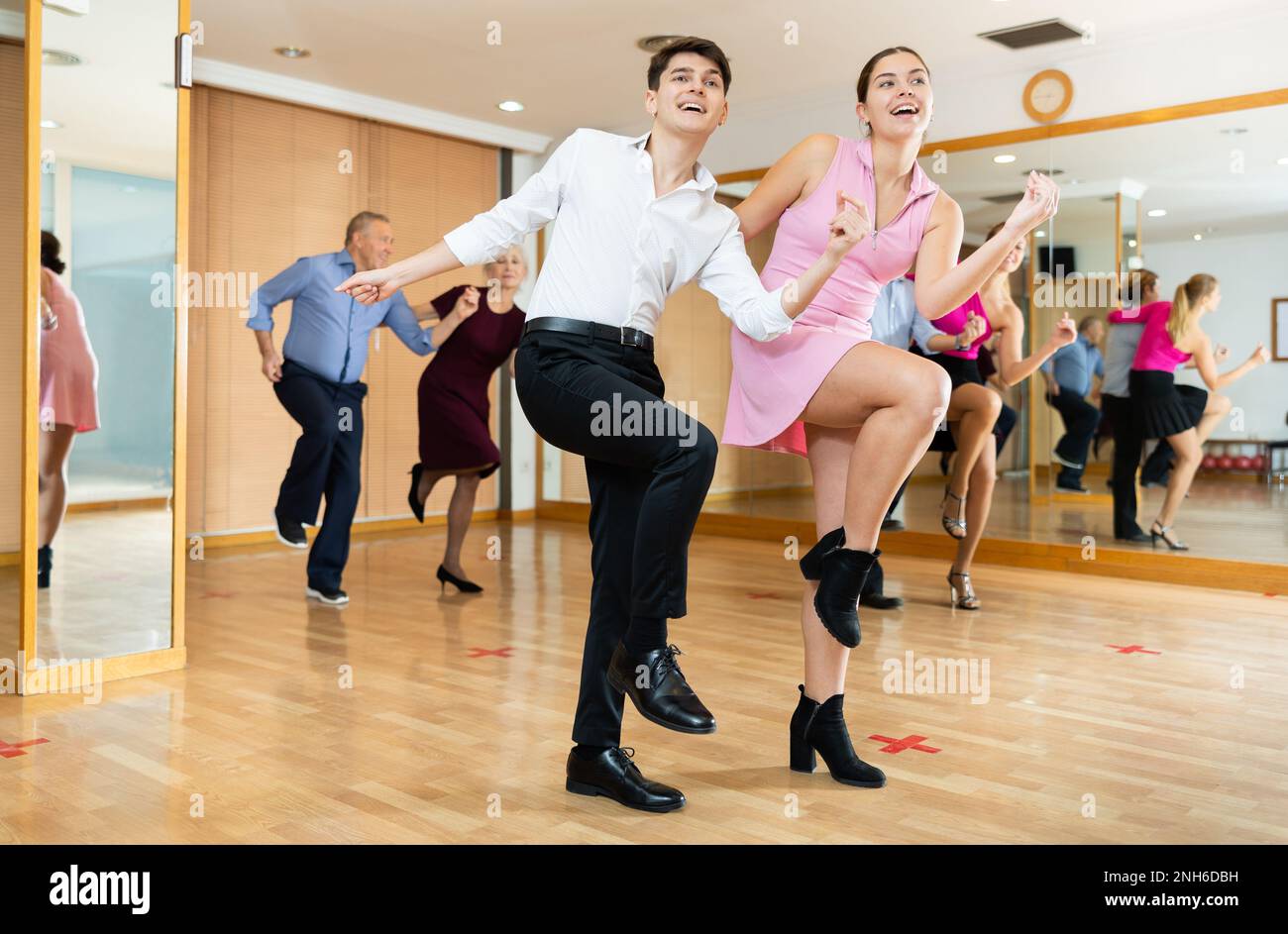 Young happy couple performing a paired dance in ballroom Stock Photo ...