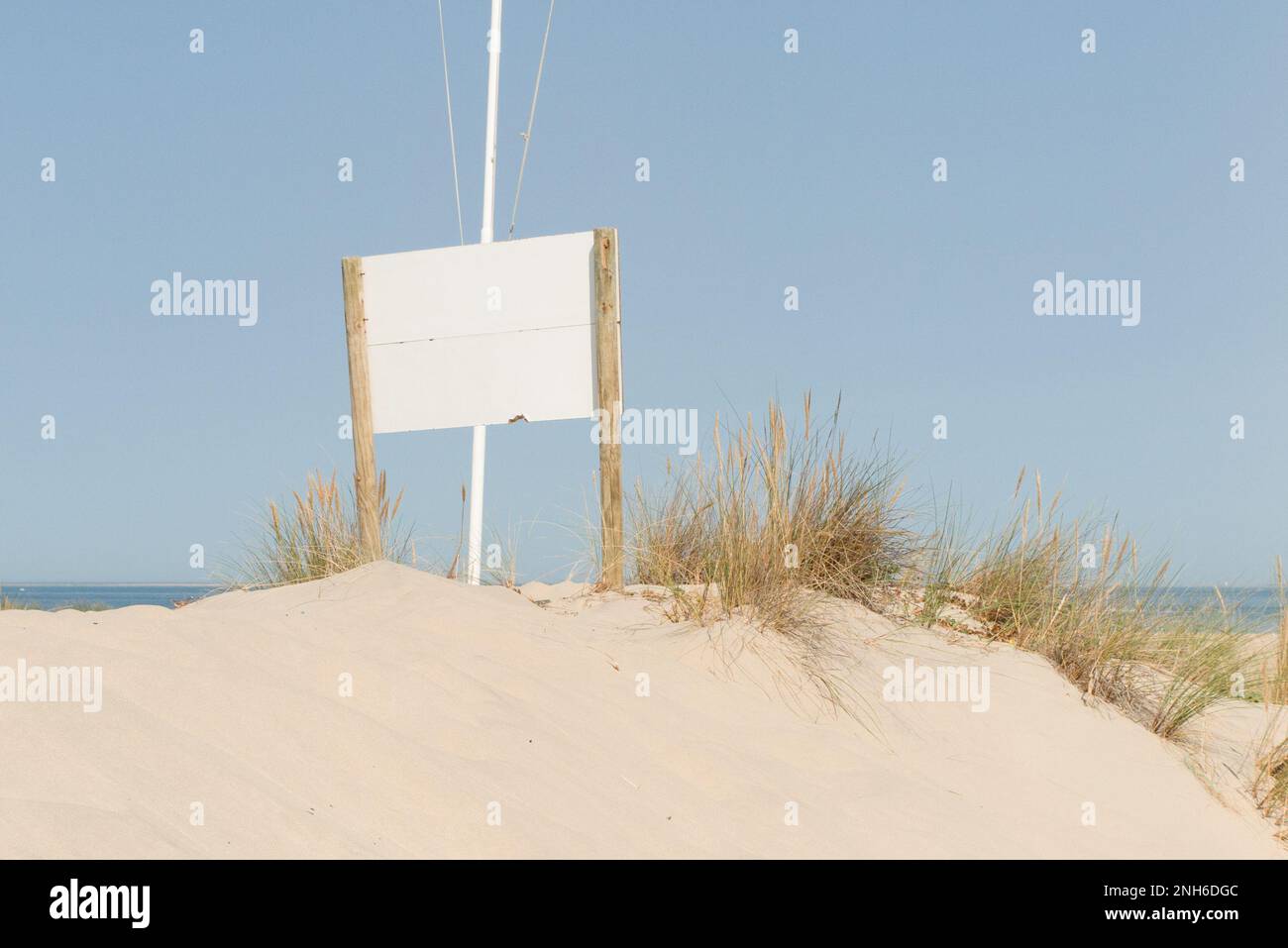 Empty black board on white sand beach with warm sunlight Stock Photo ...