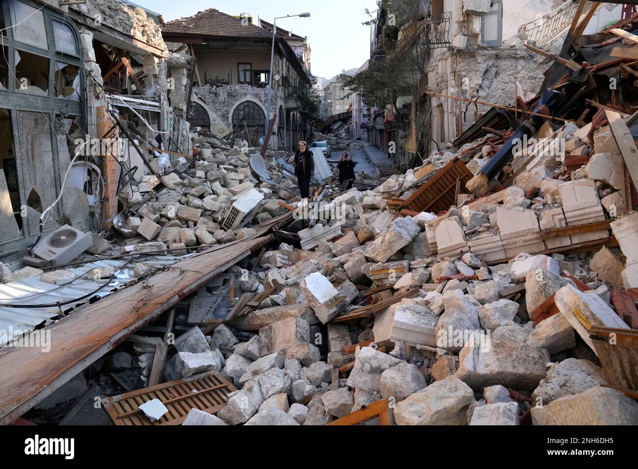 A Turkish woman stands on the debris of heritage houses that destroyed ...