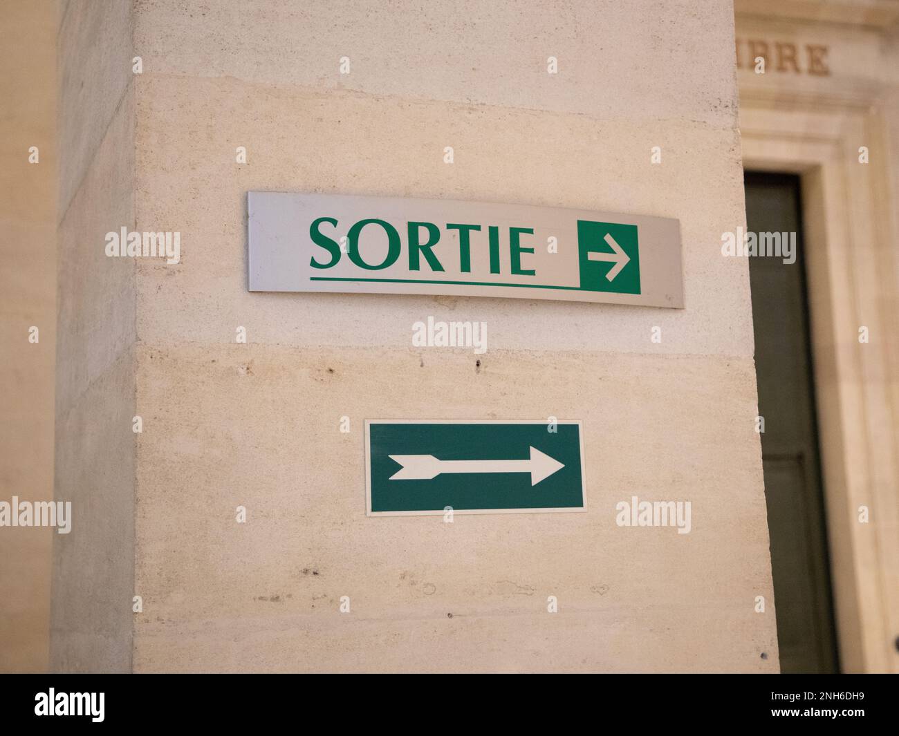 exit sign with arrow indicating in french text sortie means exit Stock ...