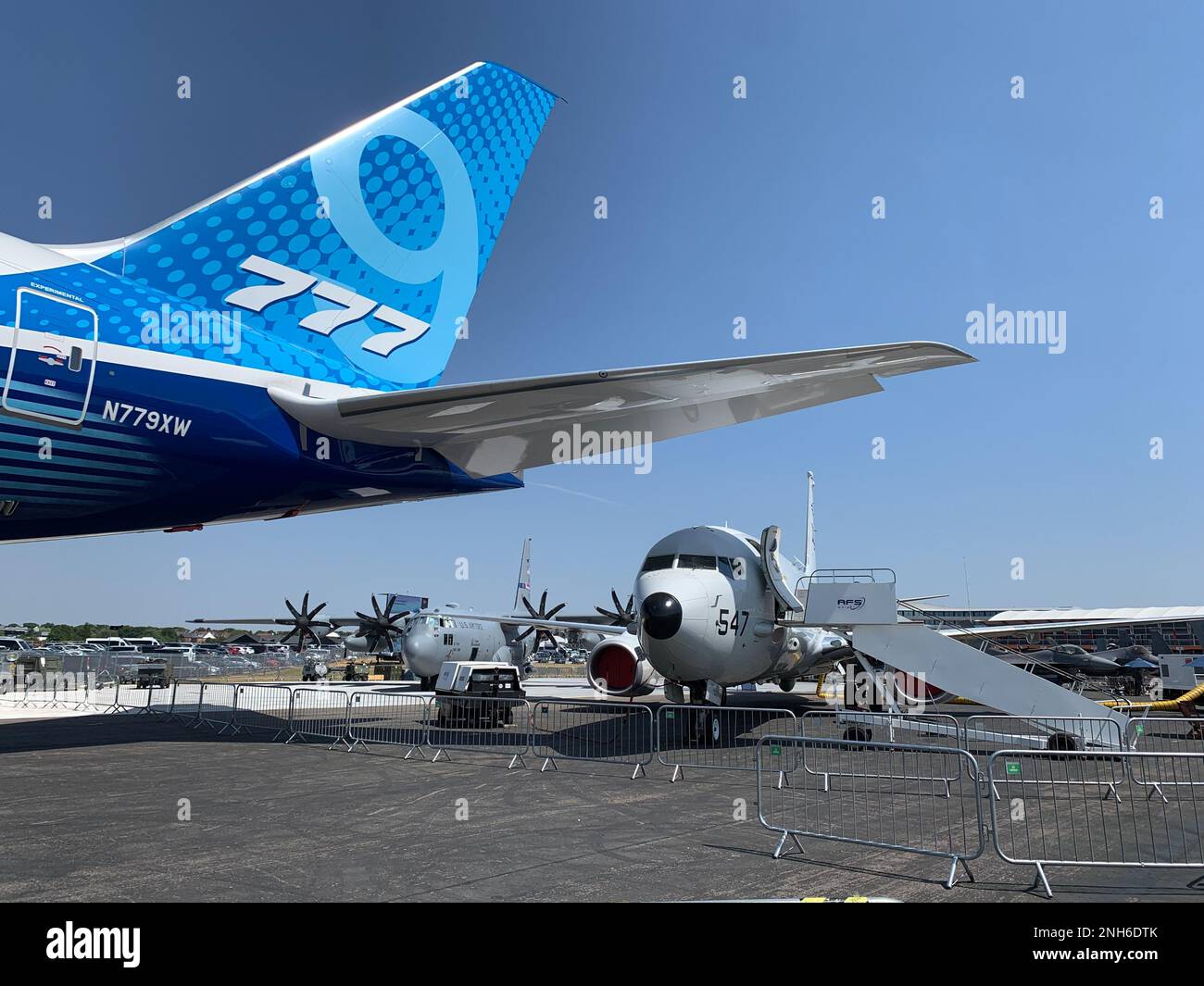 The Boeing P-8A Poseidon behind a Boeing 777 on the flight line at the ...