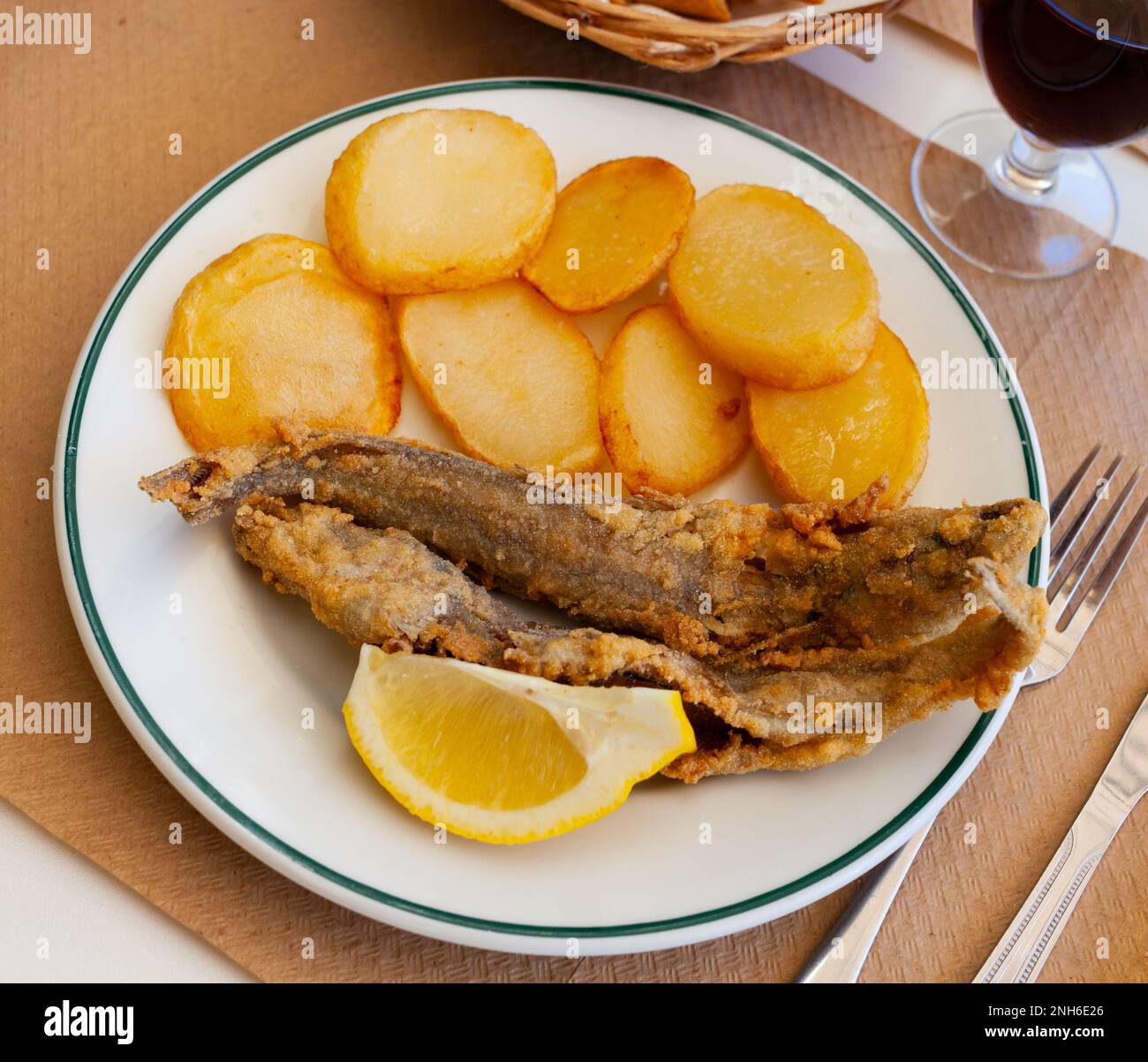 Fried blue whiting fish with potato Stock Photo - Alamy