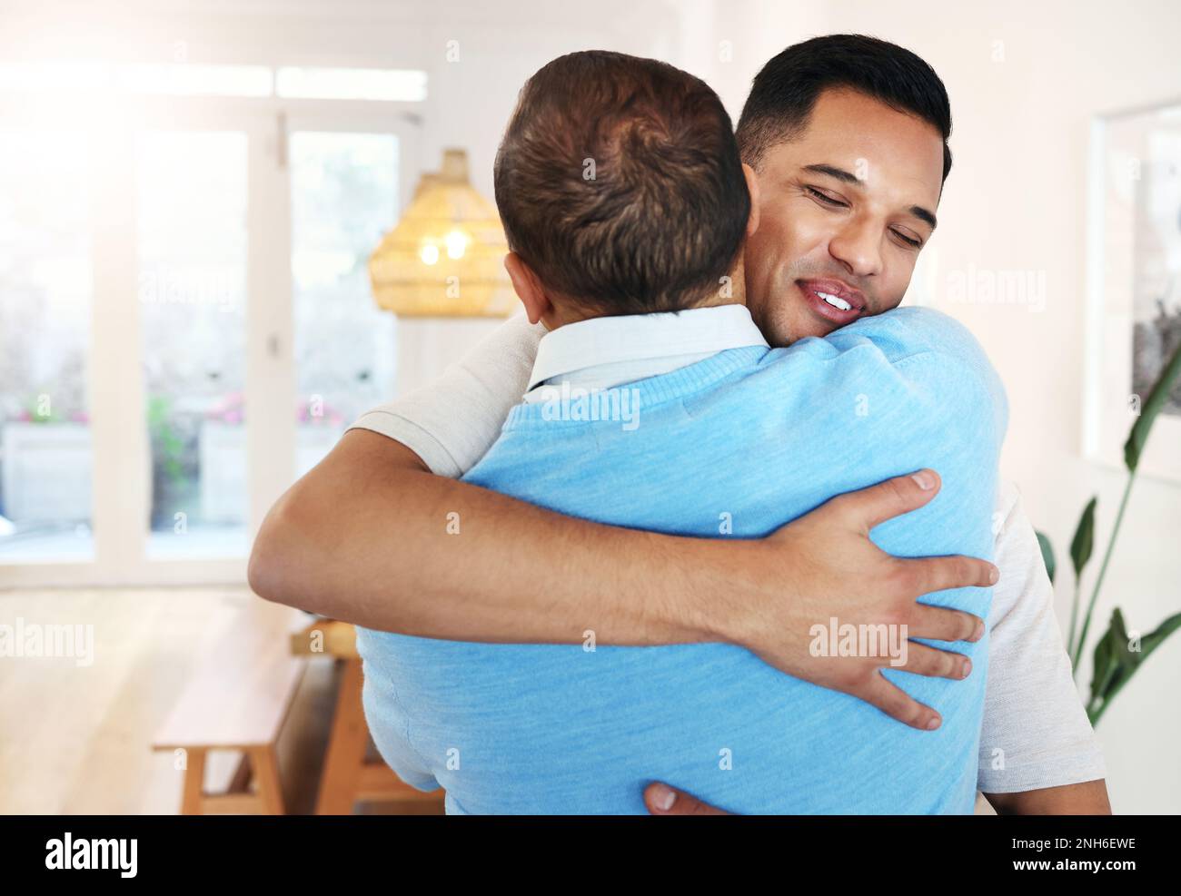 Love, care and father and son with a hug for a visit, bonding and ...