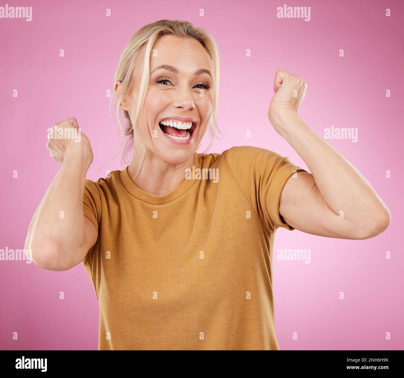 Excited, winner and winning mature woman cheering for a prize isolated ...