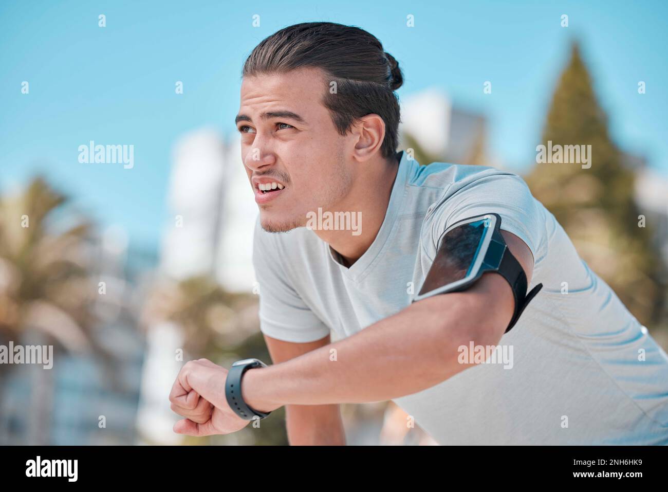 Smart watch, outdoor workout and man tired from exercise, fitness and ...