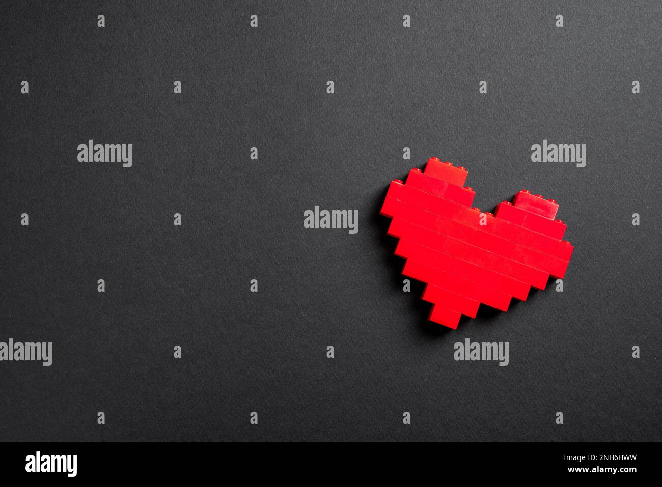 Red heart made of plastic bricks on a dark gray background Stock Photo ...