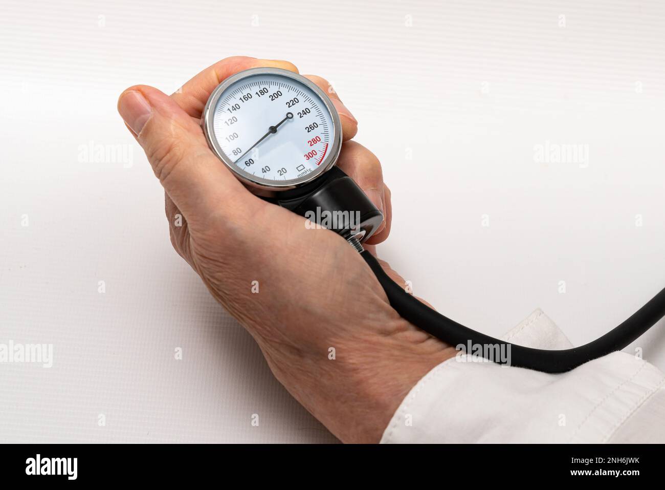 The doctor's hand holds a manometer from a device for measuring blood ...