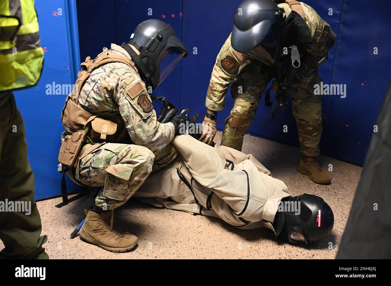 U.S. Air Force Airmen handcuff a simulated shooter at Davis-Monthan Air ...