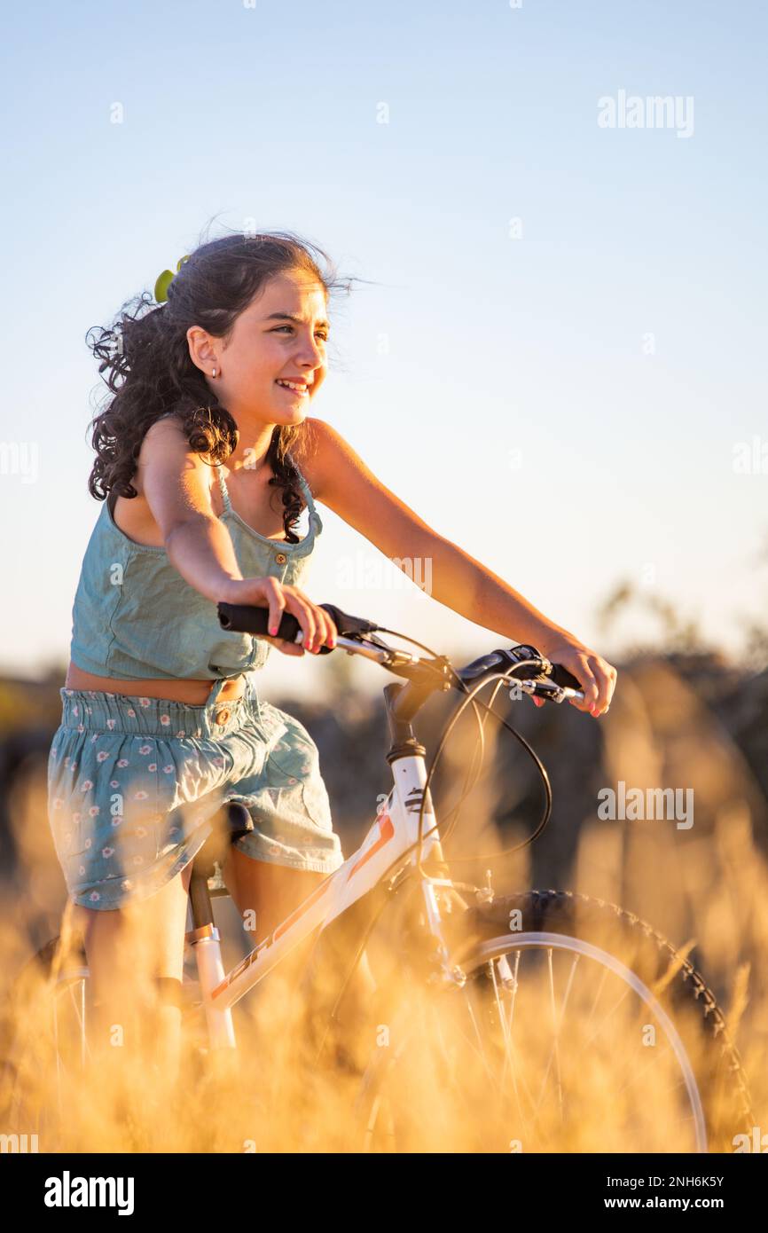 Cute girl with her bike at summer Stock Photo - Alamy