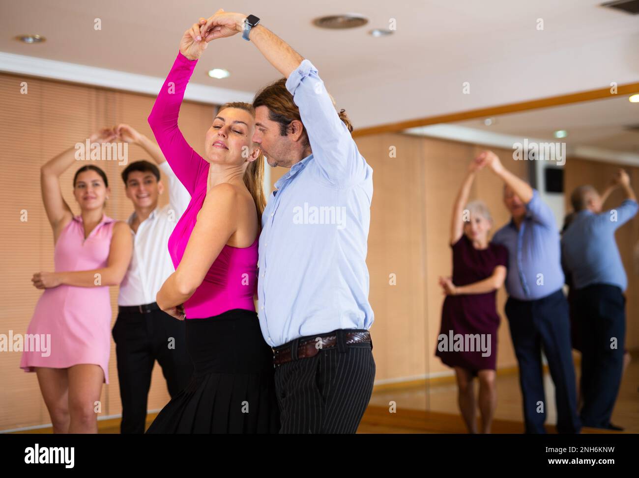 Middle-aged pair practicing ballroom dance in dance studio Stock Photo ...