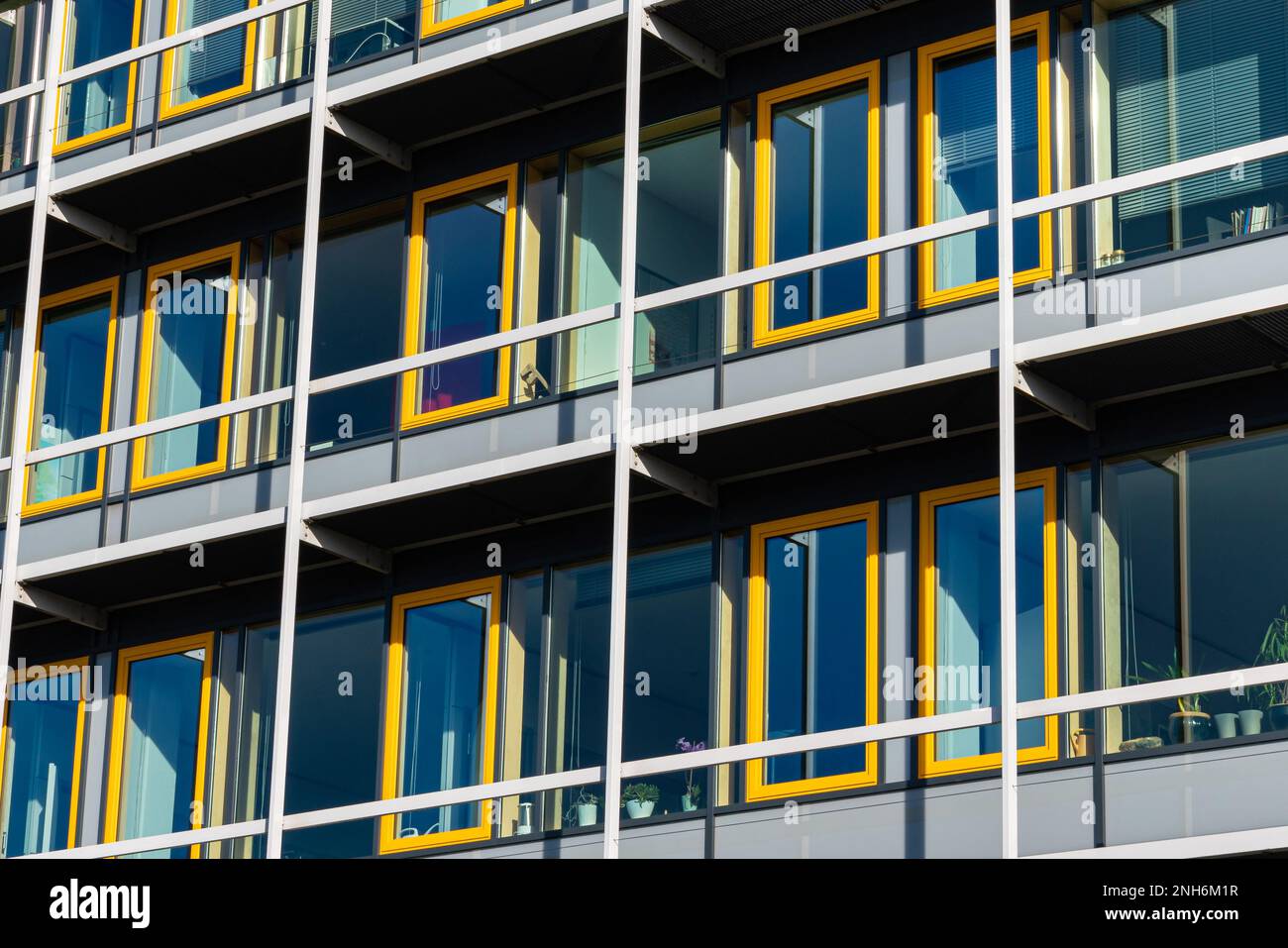 Fragment of the facade of the building with rectangular yellow windows ...