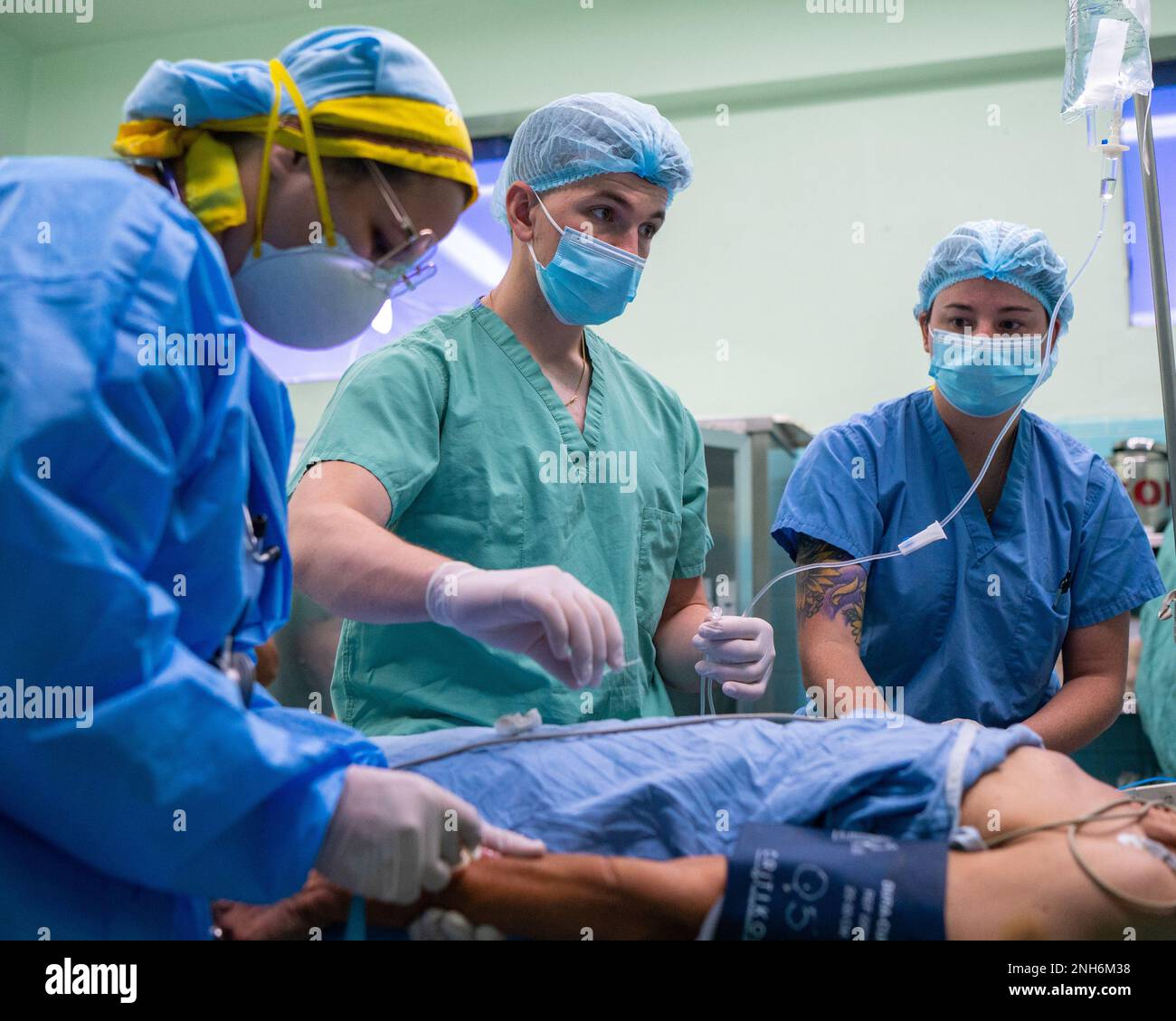 From left, a medical staff member with Hospital Escuela, U.S. Army Spc ...