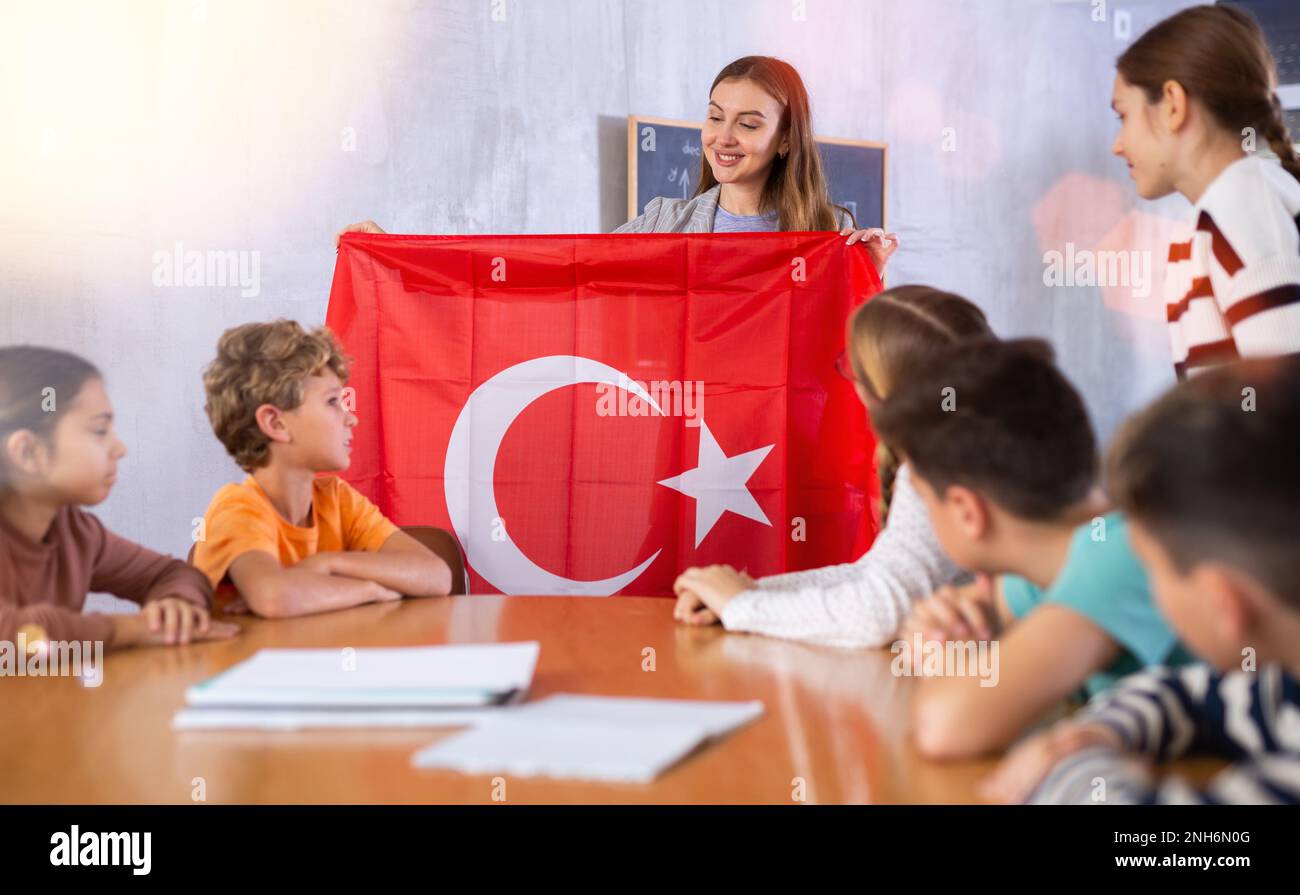 Female teacher working with teenage students in school class, talking ...