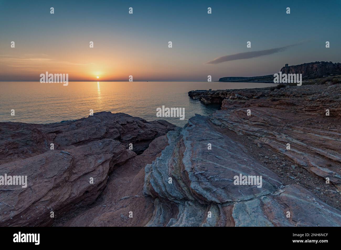 Sun setting over the rocky bay of Macari, Sicily Stock Photo - Alamy