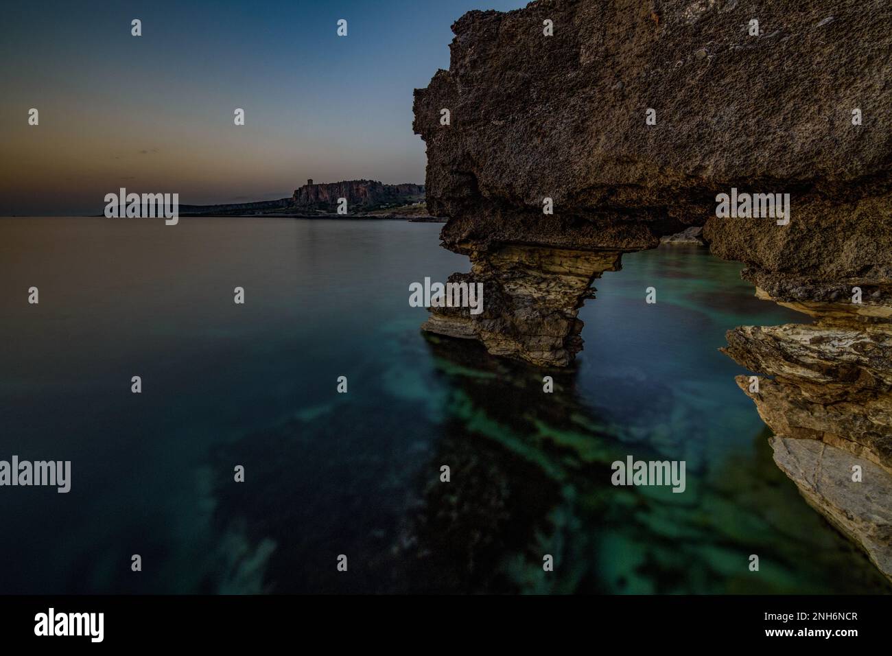Marine arch in Macari bay at dusk, Sicily Stock Photo - Alamy