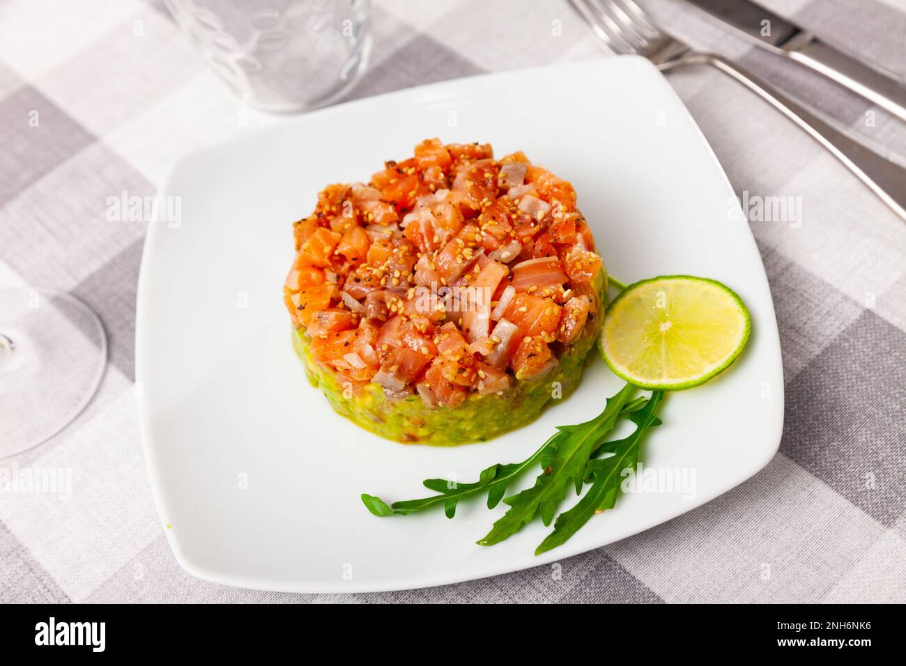 Salmon tartare with guacamole and slice of lime Stock Photo - Alamy