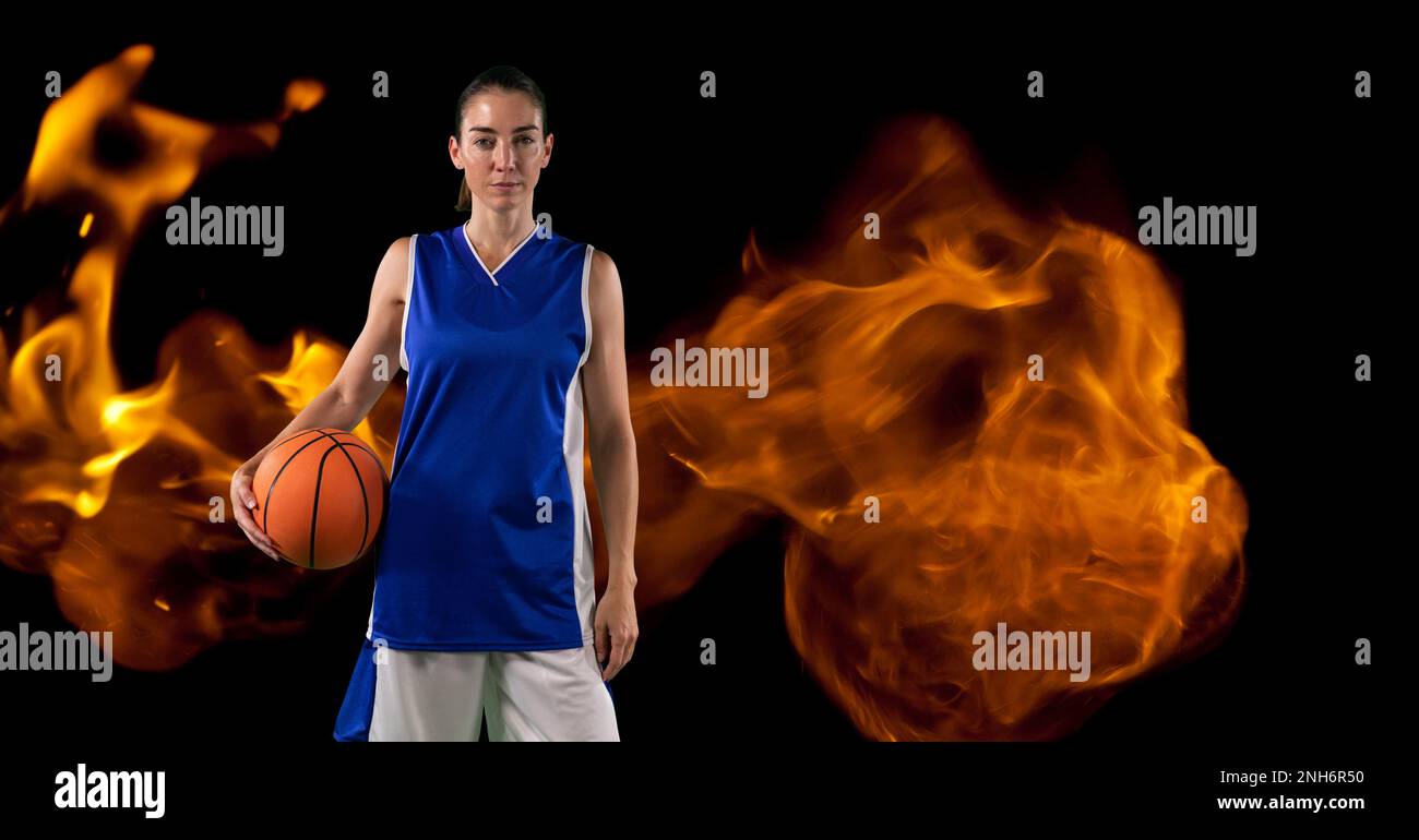 Composition of female basketball player standing holding ball over ...