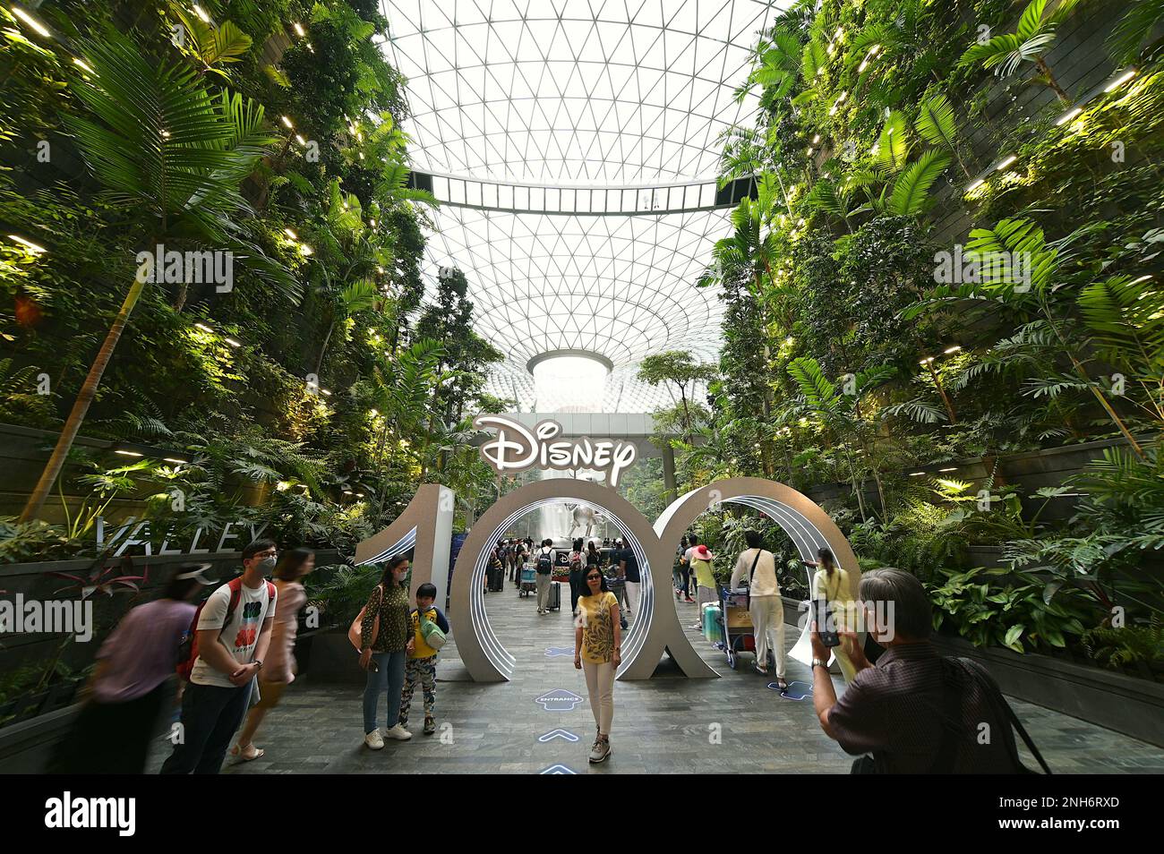 Visitors posing for pictures before the Rain Vortex and large Disney ...