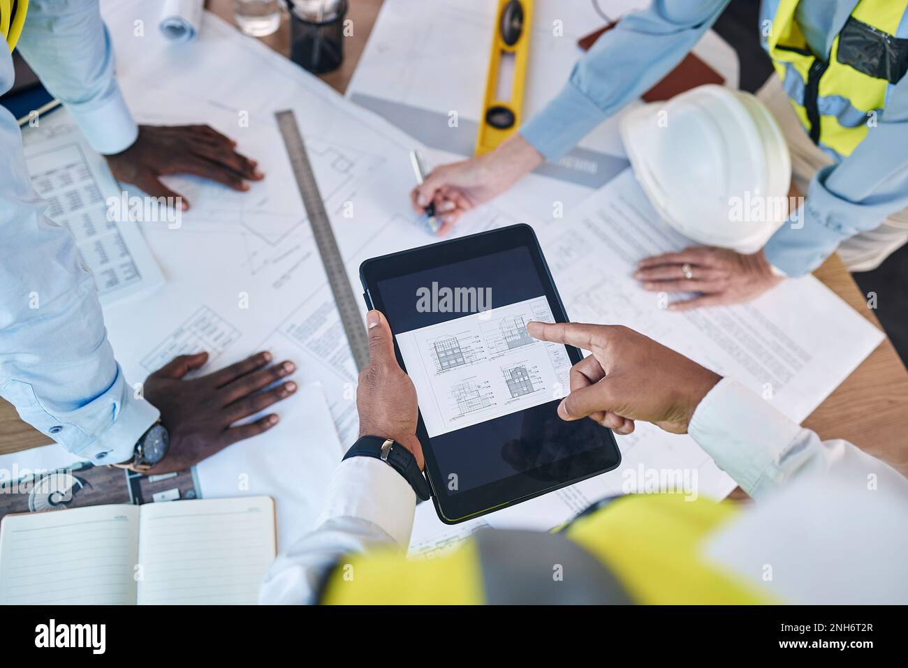 Architect, hands and tablet in construction above for team planning ...