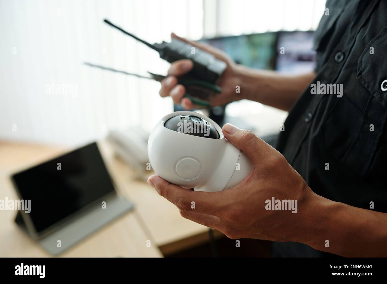 Hands of security officer holding surveillance equipment Stock Photo ...