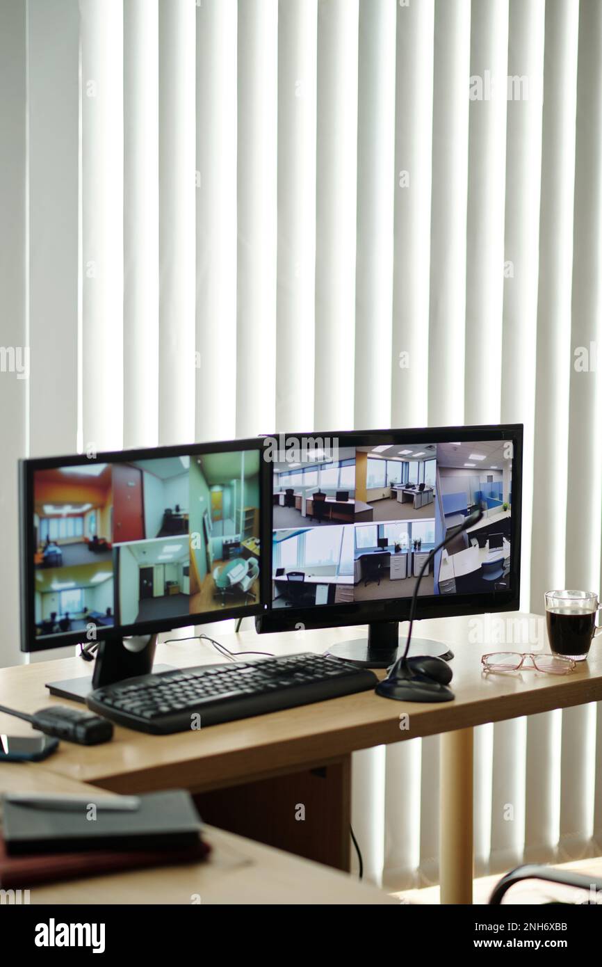 Cup of coffee and microphone next to monitors in office of security ...
